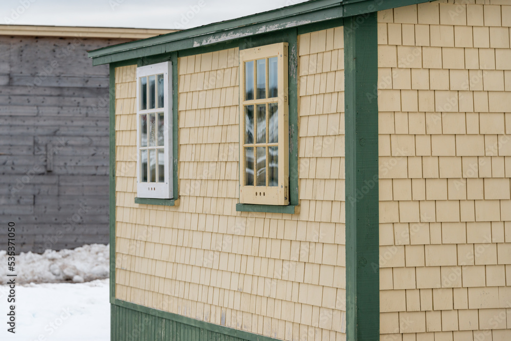 A vintage yellow cedar shake clapboard house with a grey shingled ...