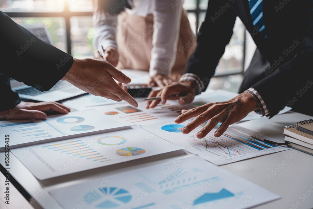 Image of a businessman attending a meeting pointing to a graph to think ...