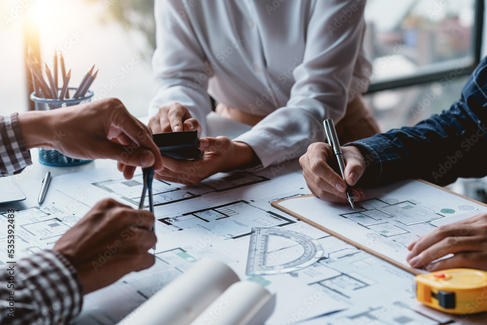 Project planning meeting engineers or architects drawing models working ...