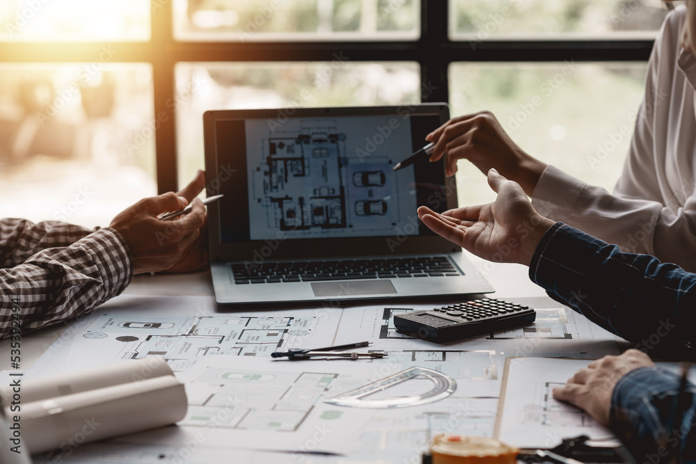 Project planning meeting engineers or architects drawing models working ...