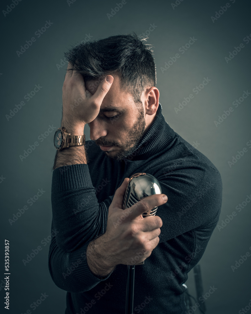 Sad man holding microphone Stock Photo | Adobe Stock