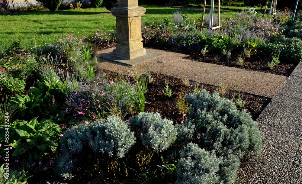 beautifully landscaped surroundings are decorated with a stone plinth ...