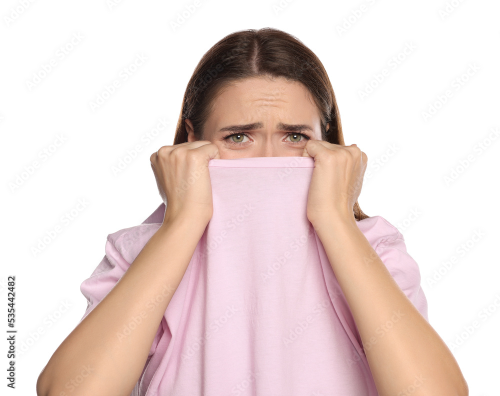 Embarrassed young woman covering face with shirt on white background ...