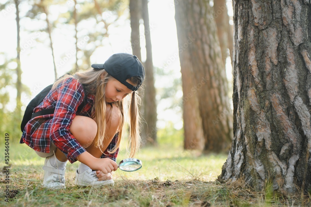 Image of cute kid with magnifying glass exploring the nature outdoors ...
