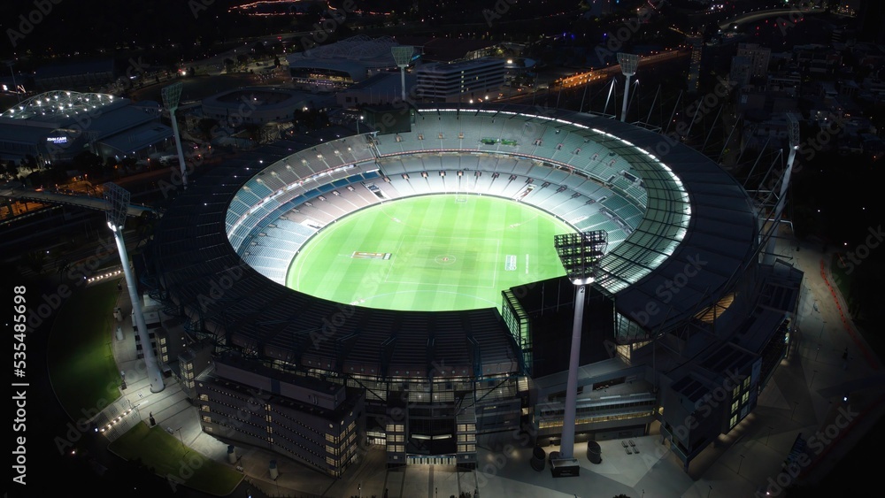 Aerial of the MCG sports stadium in Melbourne lighted up at night ...