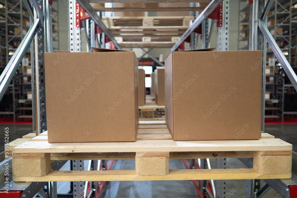 Cardboard parcels. Metal rack with boxes. Two square parcels on pallet ...