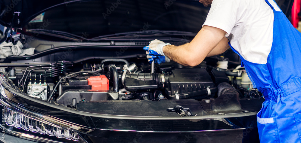 Professional car technician mechanic team in uniform work fixing ...