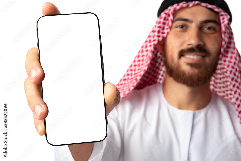 Young Arab muslim man in traditional clothes showing mobile phone ...