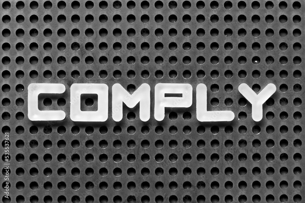White alphabet letter in word comply on black pegboard background Stock ...
