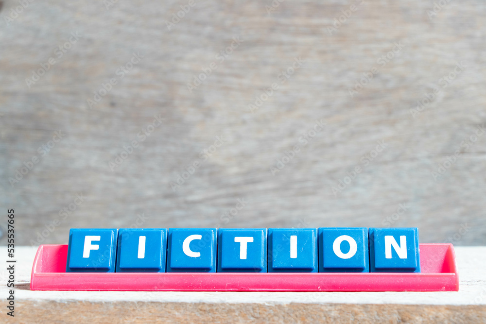 Tile alphabet letter with word fiction in red color rack on wood ...