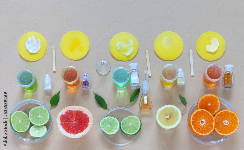 Samples of vitamin anti-aging cosmetics with citrus extracts. Sliced ...
