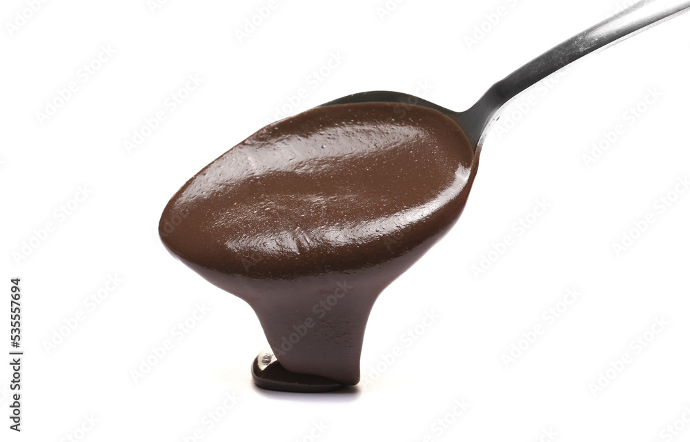 Sesame butter dripping with cocoa, tahini paste in spoon isolated on ...