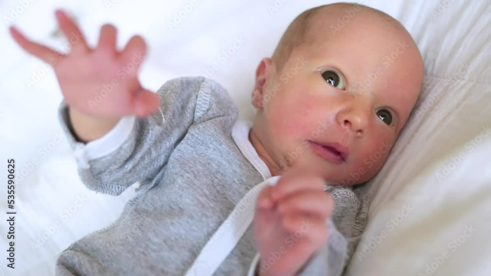 newborn. baby newborn a close-up lies looking at the camera in the ...