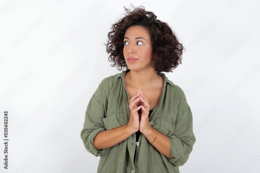 Charming cheerful young beautiful woman with curly short hair wearing ...