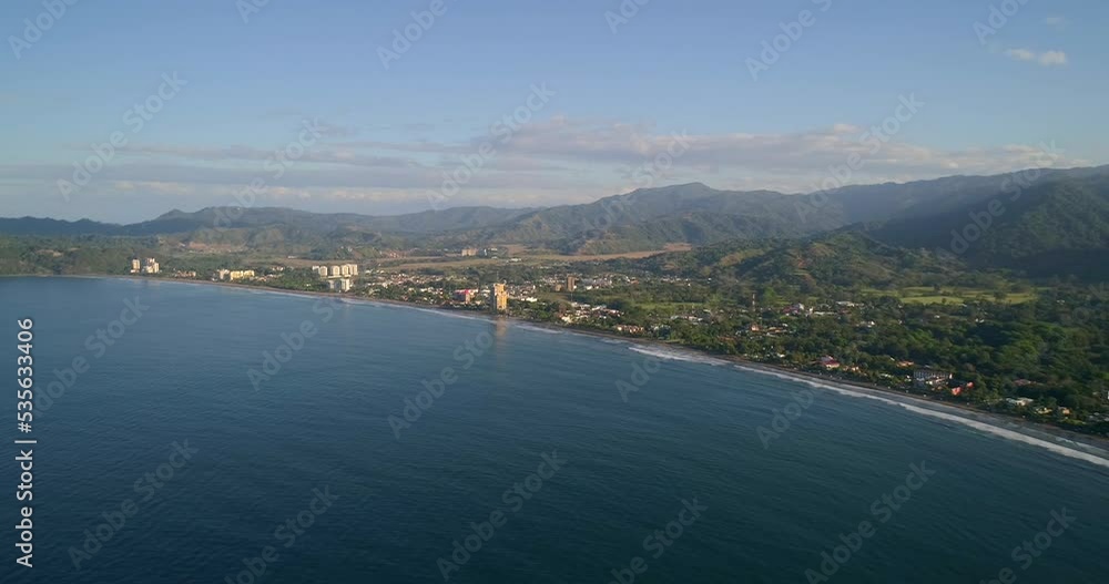 Sweeping aerial view of a Costa Rica beach and town at sunset. Stock ...