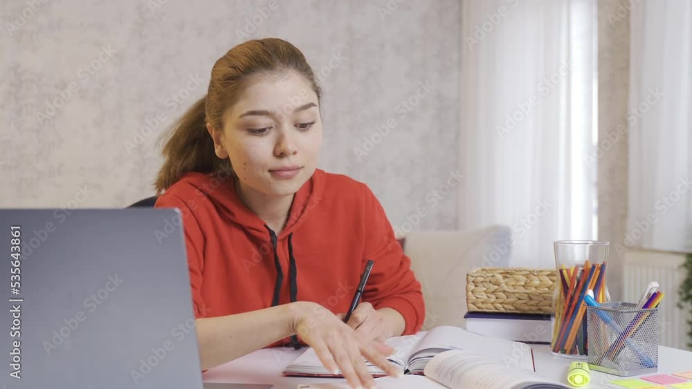 College student girl happily studying at home. The uni student who ...