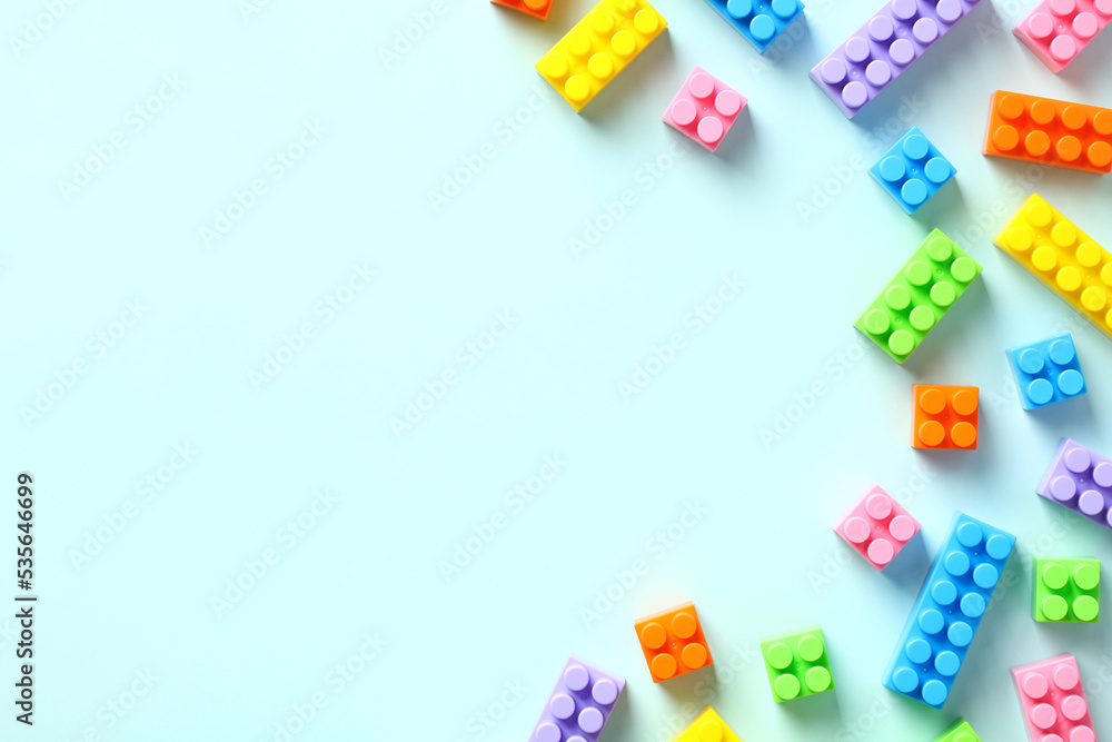 Colorful plastic building blocks on pastel blue background. Flat lay ...