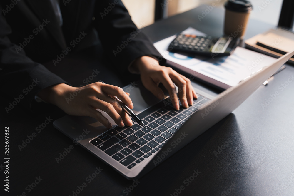 Close-up businessperson typing and searching data internet on laptop ...