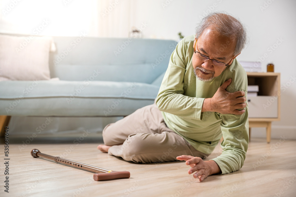 Sick senior old man falling down lying on floor because stumbled at ...