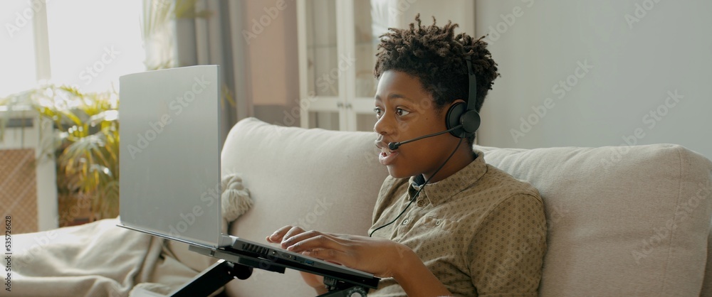 DX Portrait of African American Black kid playing online games on his ...