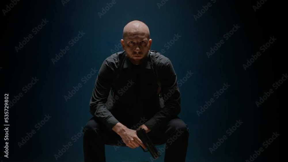 Portrait of FBI agent who holds service pistol in his hand. Police ...