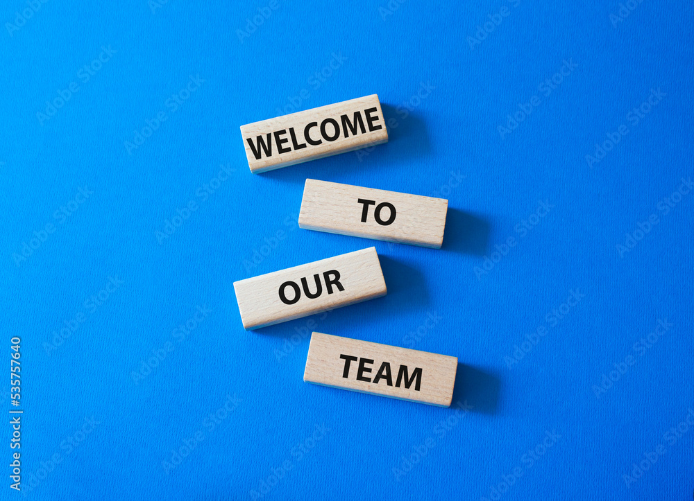 Welcome to our team symbol. Concept words Welcome to our team on wooden blocks. Beautiful blue ...