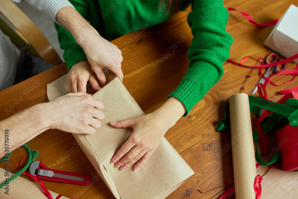 Top view image of man and woman wrapping presents together at home ...