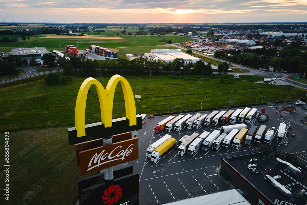 McDonalds logo with McCafe sign near highway, aerial view. McDonald's ...