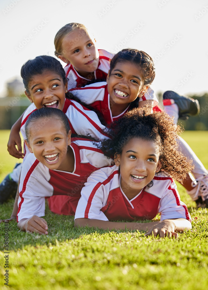 Team, children and happy on field in sports after win in match, game or ...