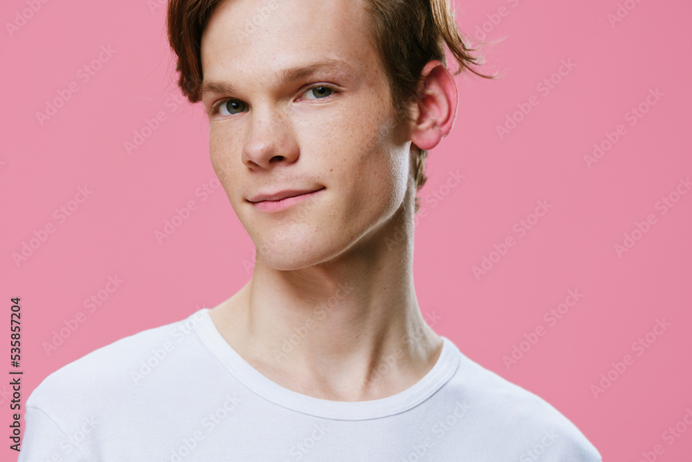 red-haired, attractive guy with freckles on his face, looking at the ...