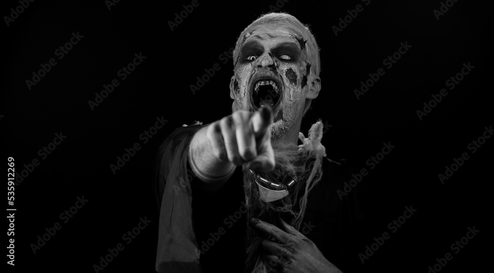 Sinister man in carnival costume of Halloween crazy zombie with bloody ...