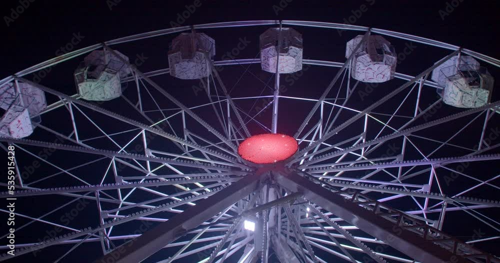 Entertainment at the night event. Ferris wheel movement in night sky ...