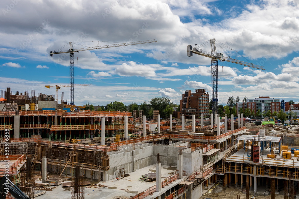 Large construction site with construction cranes working on a ...