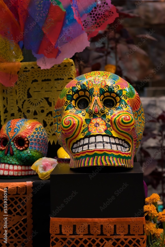 Colorful and painted day of the dead skull, calaveras on an altar with ...