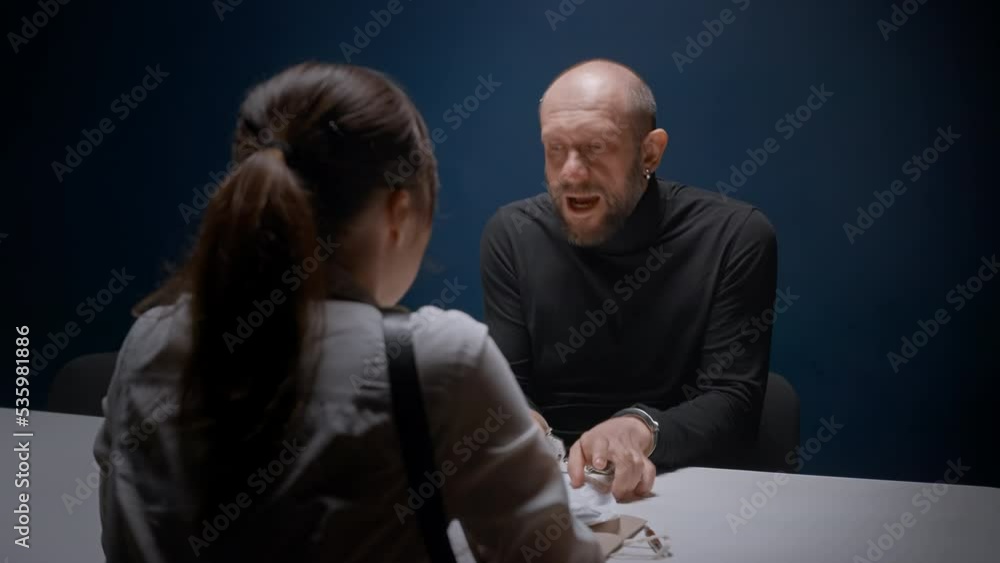 Aggressive suspect criminal in handcuffs denies his guilt and shouts at ...