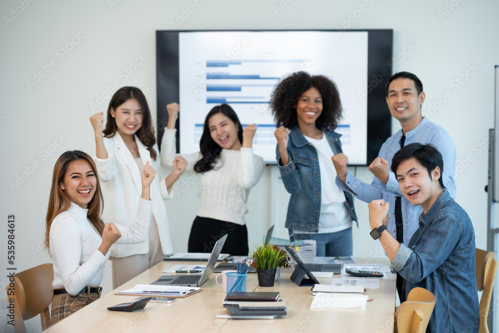 Group of creative young Asian business people happy, successful work, accomplished goals ...