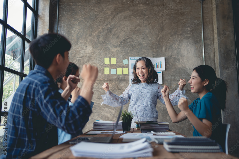 Group of creative young Asian business people happy, successful work ...