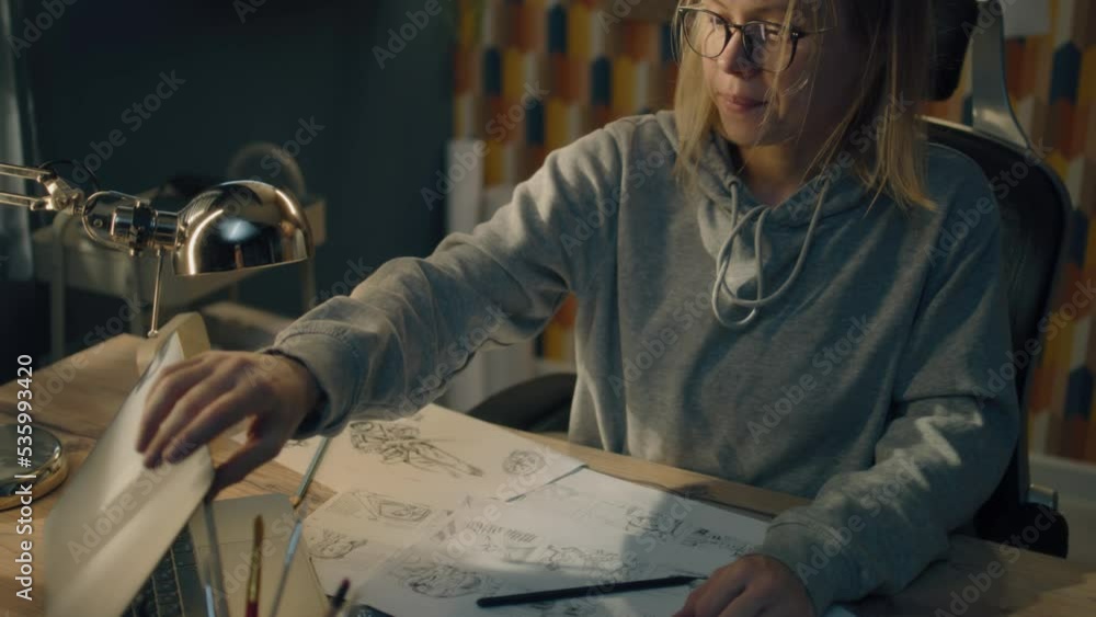 Female animator finishes her sketches for the storyboard. Shuts down ...