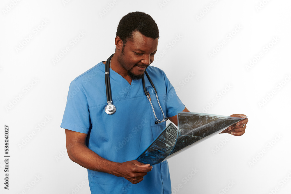Black surgeon doctor bearded man in blue coat with stethoscope holds X ...
