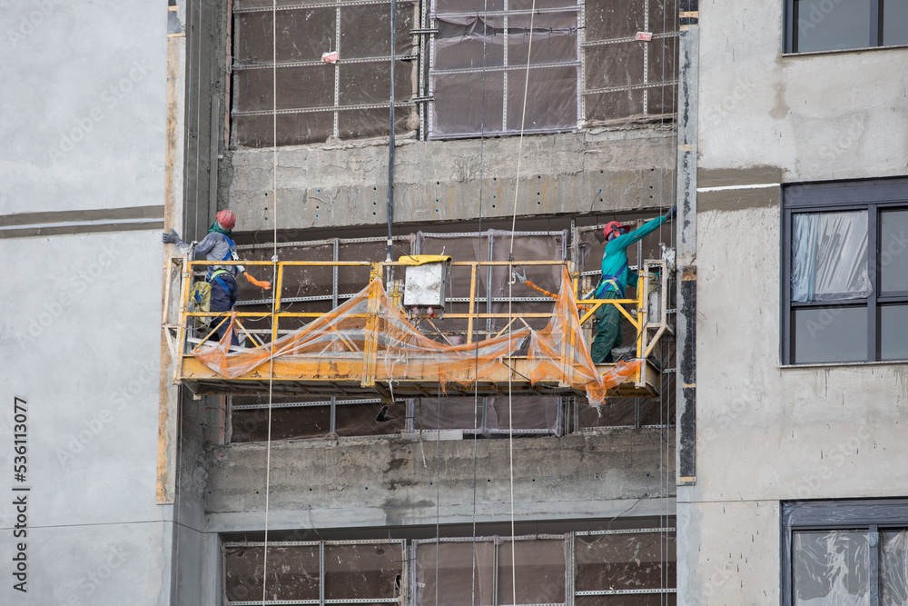 suspended scaffold at construction of a building Stock Photo | Adobe Stock