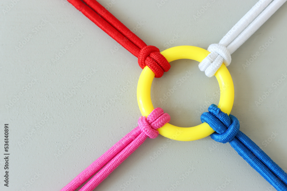 Foto de Concept image of unity and teamwork. Ropes tied together as a ...
