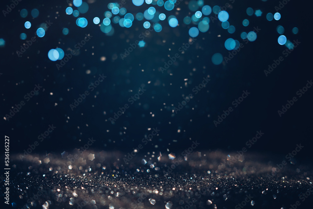 Glowing in the dark defocused glitter texture with blue bokeh lights and snow. Christmas and ...