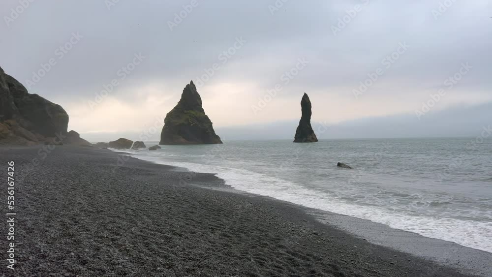The iconic black sand beaches of Reynisfjara and the sea stacks ...
