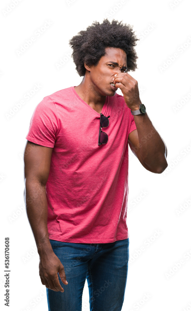 Afro american man over isolated background smelling something stinky ...