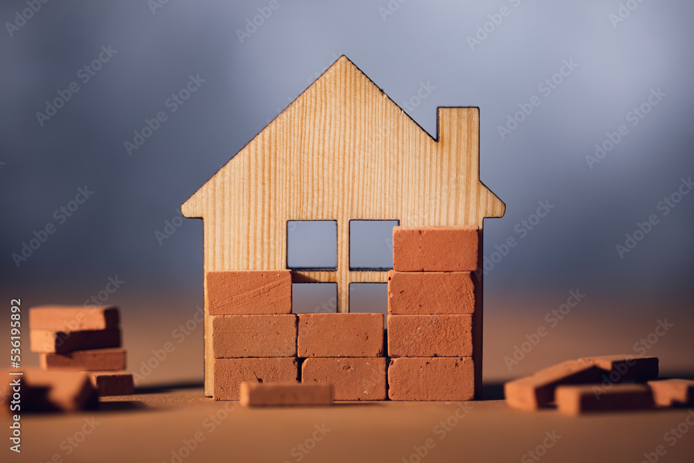 Wooden house model and bricks Stock Photo | Adobe Stock