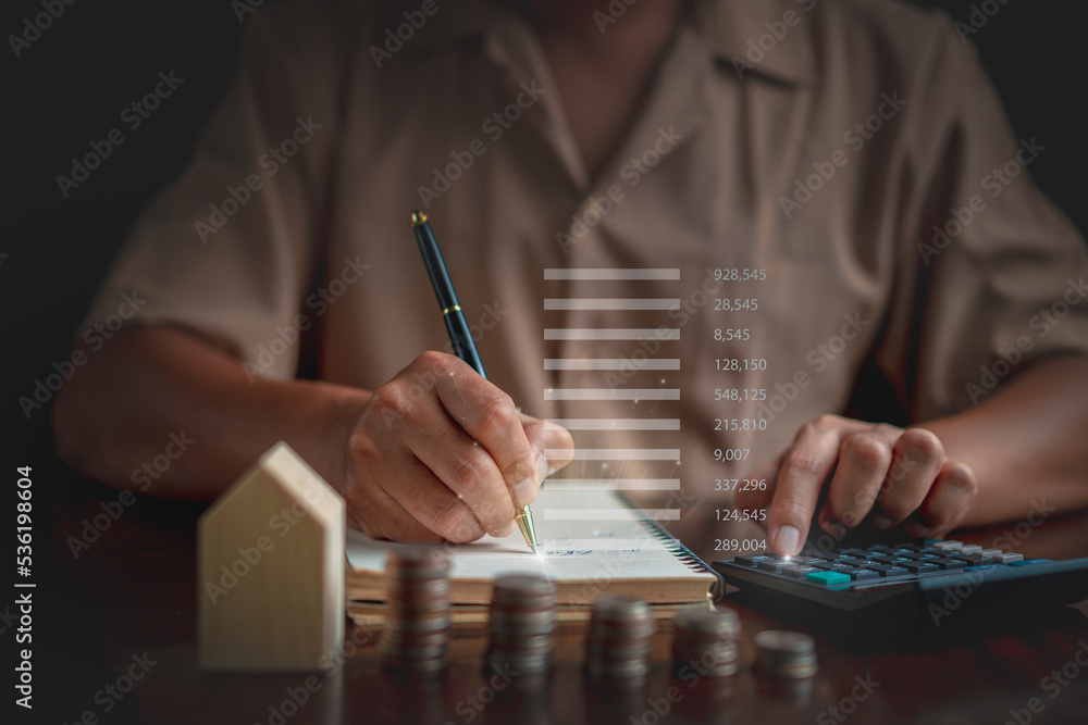 Businessman taking notes and using calculator to calculate, Stacking ...