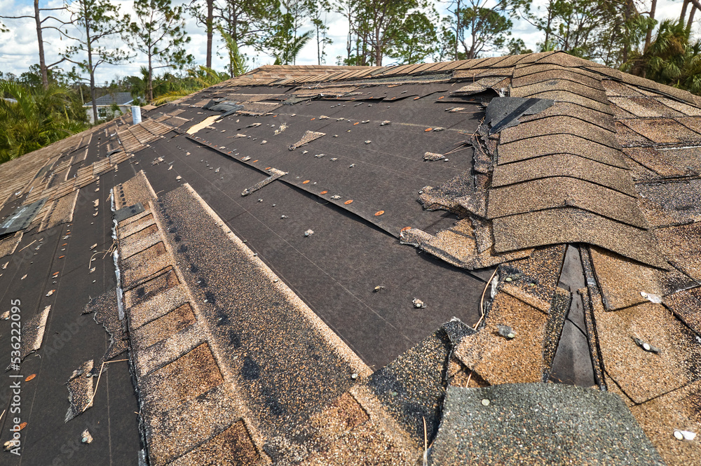 Hurricane Ian destroyed house roof in Florida residential area. Natural ...