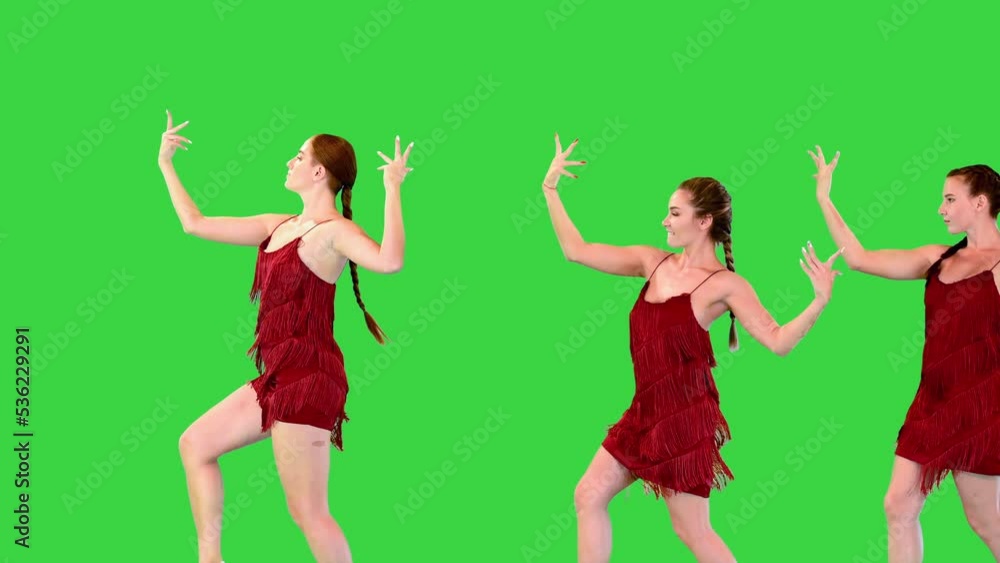Three beautiful ladies in red stage costumes walk expressively, making ...