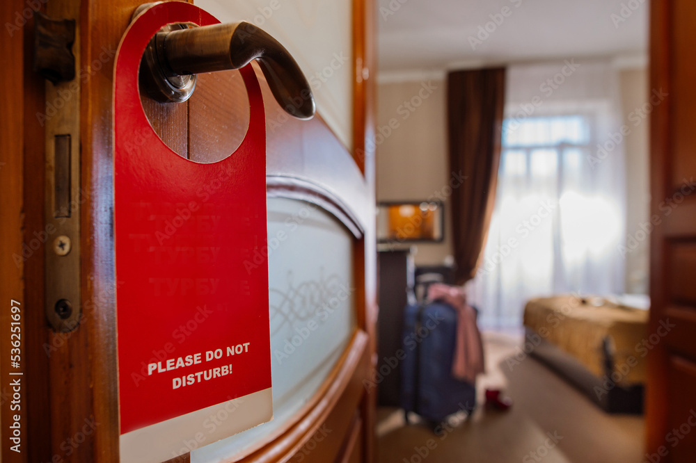 Do not disturb card hang on the hotel room doors Stock Photo | Adobe Stock