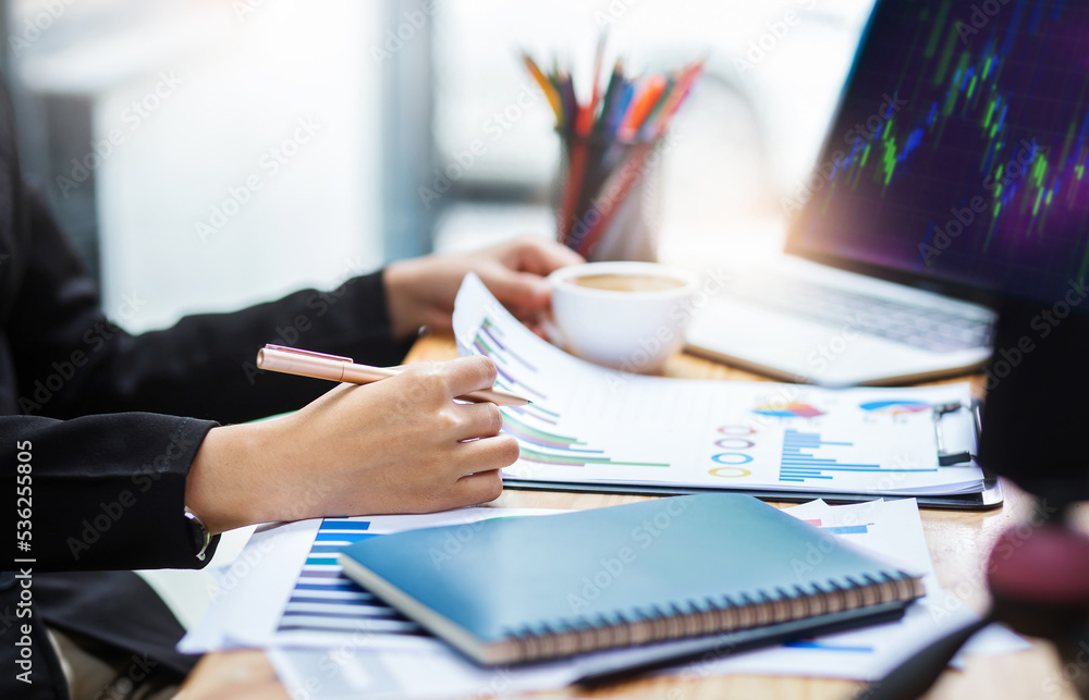 young asian businesswoman working on desk holding pen and use paperwork ...